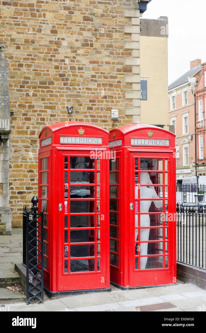 Red telephone box with fullsize statue of a man inside in St Giles ...