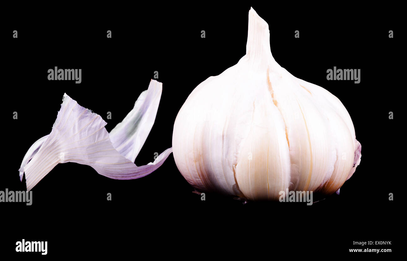 Single garlic head isolated on a black background Stock Photo - Alamy
