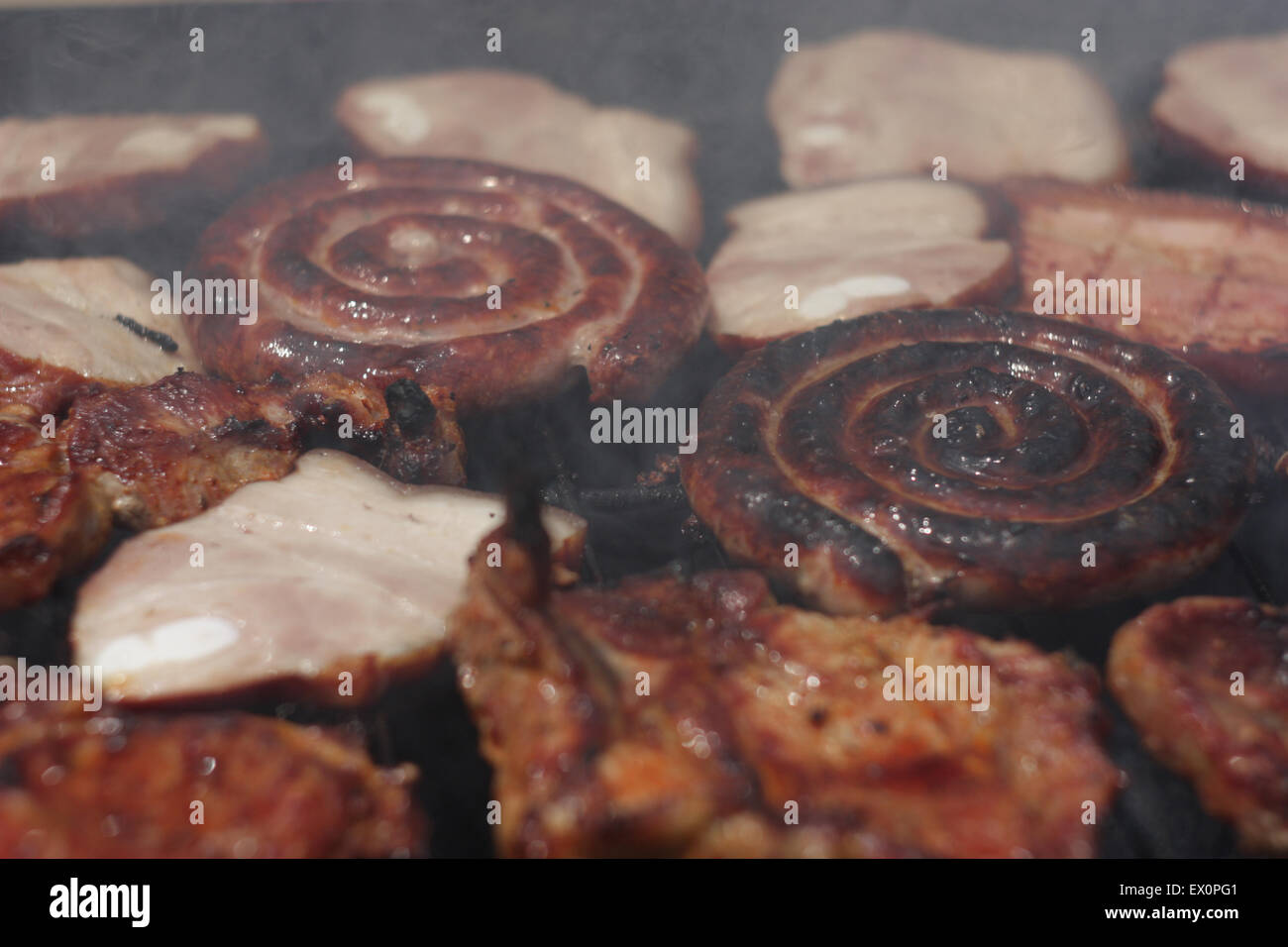 Barbecuing meat on charcoal fire closeup image Stock Photo - Alamy