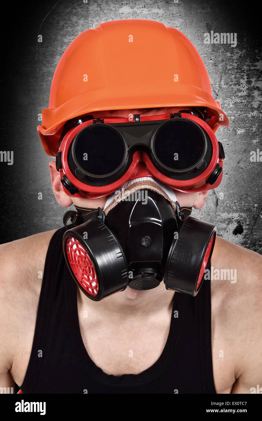 worker in biohazard mask on black background Stock Photo - Alamy