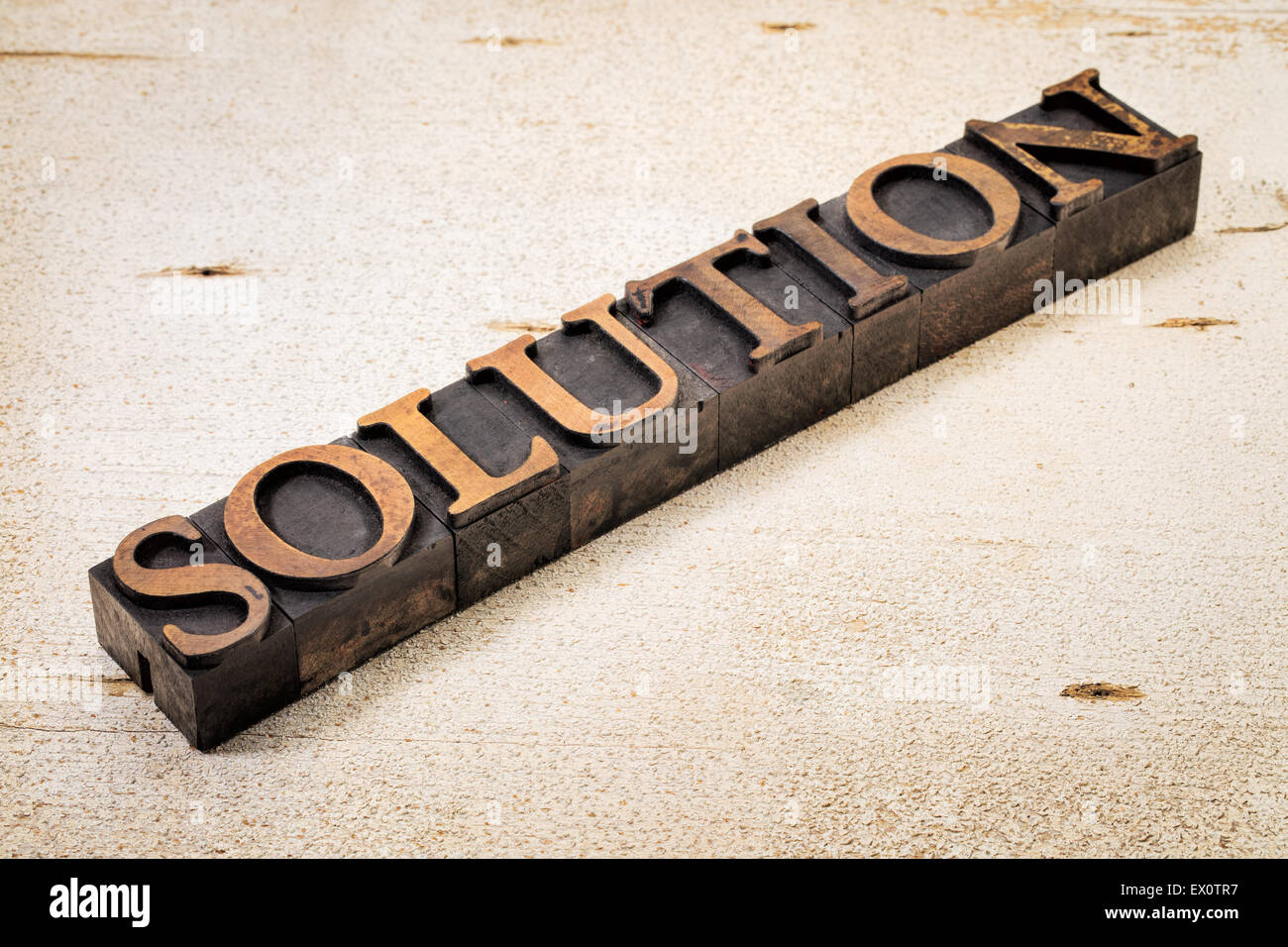 solution word in vintage letterpress wood type against white painted ...