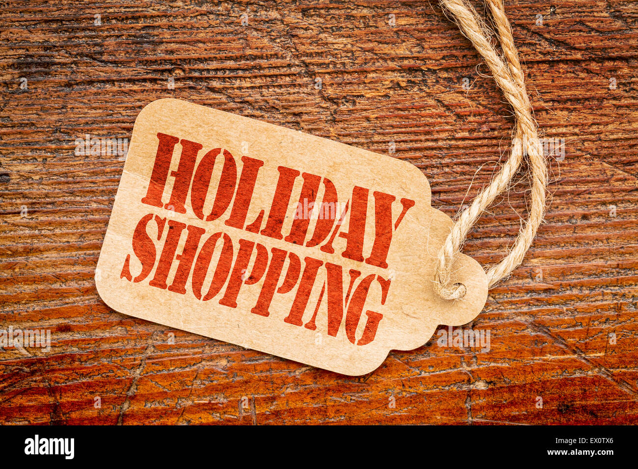 Holiday shopping sign a paper price tag against rustic red painted barn ...
