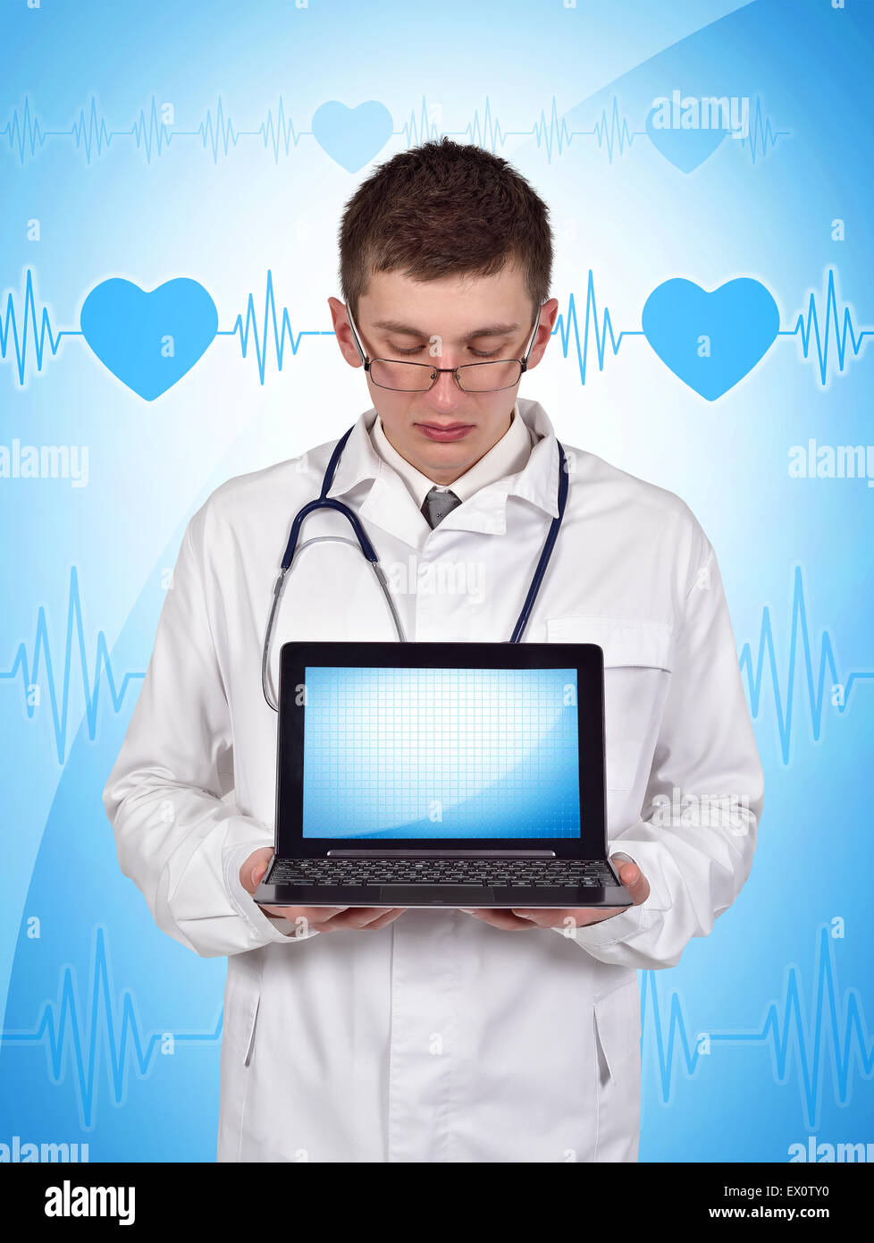 doctor holding laptop on a blue background Stock Photo - Alamy