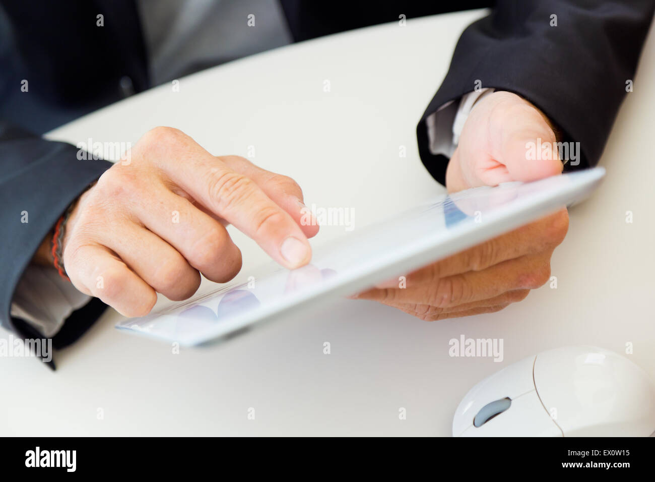 Portrait of businessman finger pointing to the screen of a digital ...
