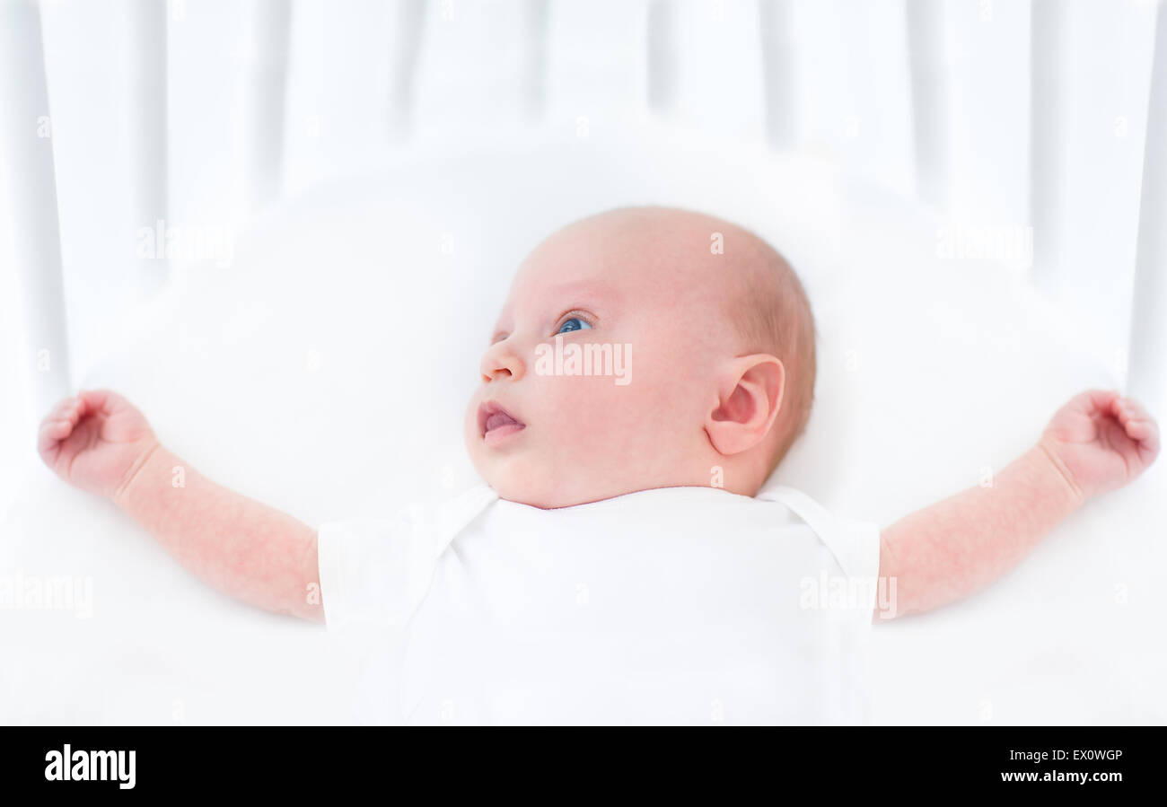 Sweet newborn baby in a white round crib Stock Photo - Alamy