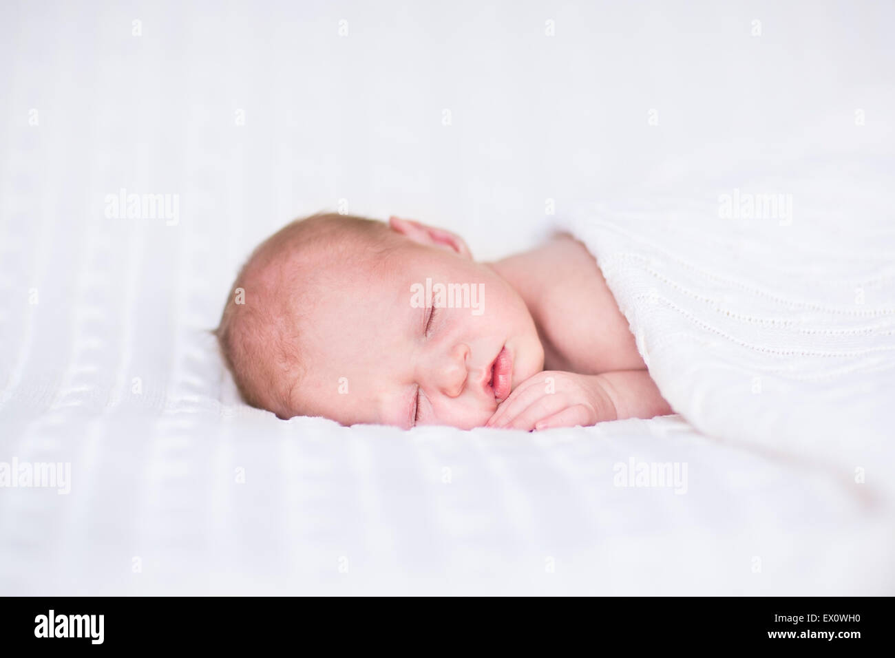 One day old newborn baby boy smiling while relaxing on his tummy Stock ...
