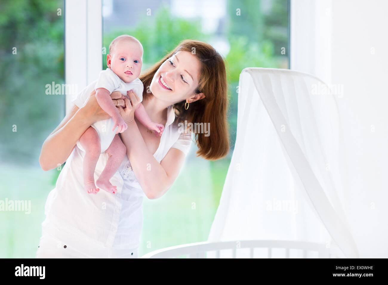 Beautiful young mother holding her sweet newborn baby Stock Photo - Alamy