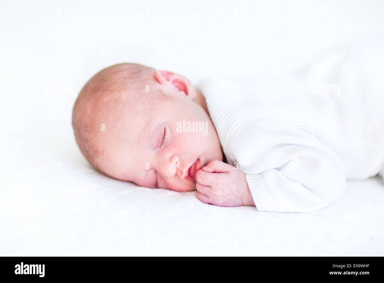 One day old newborn baby boy smiling while relaxing on his tummy Stock ...