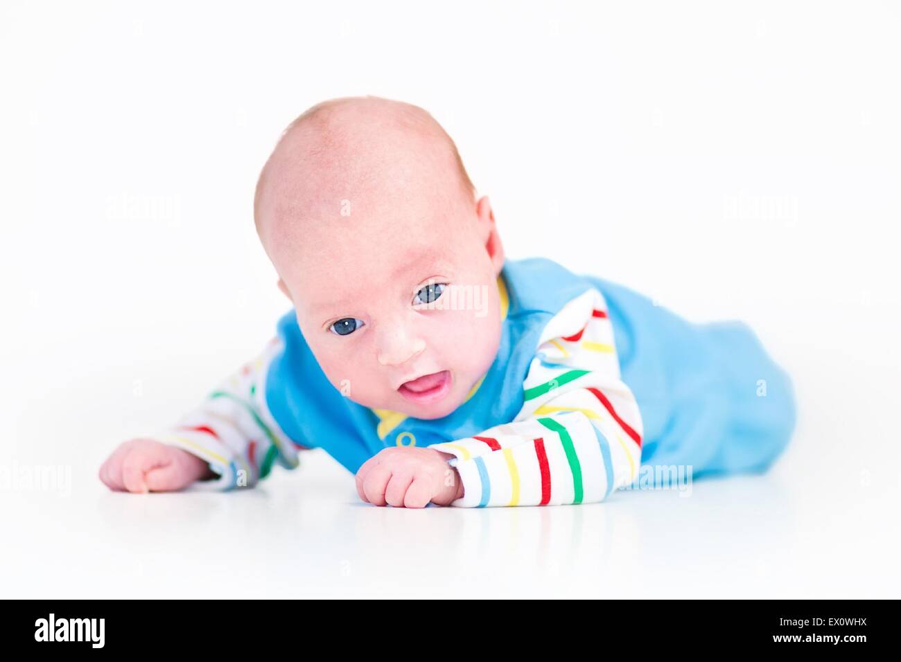 One day old newborn baby boy smiling while relaxing on his tummy Stock ...