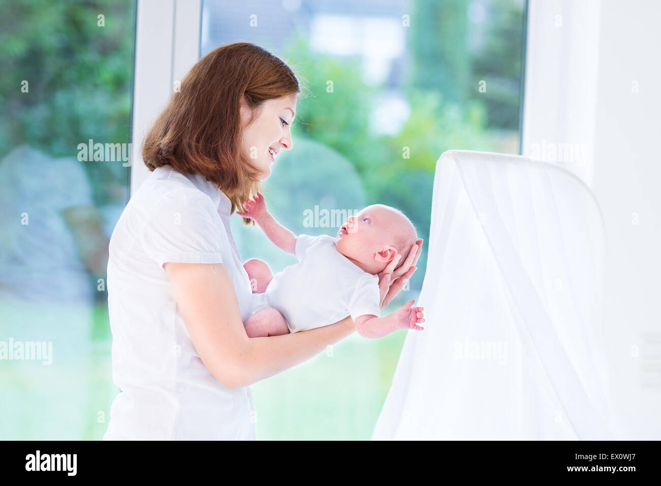 Beautiful young mother holding her sweet newborn baby Stock Photo - Alamy