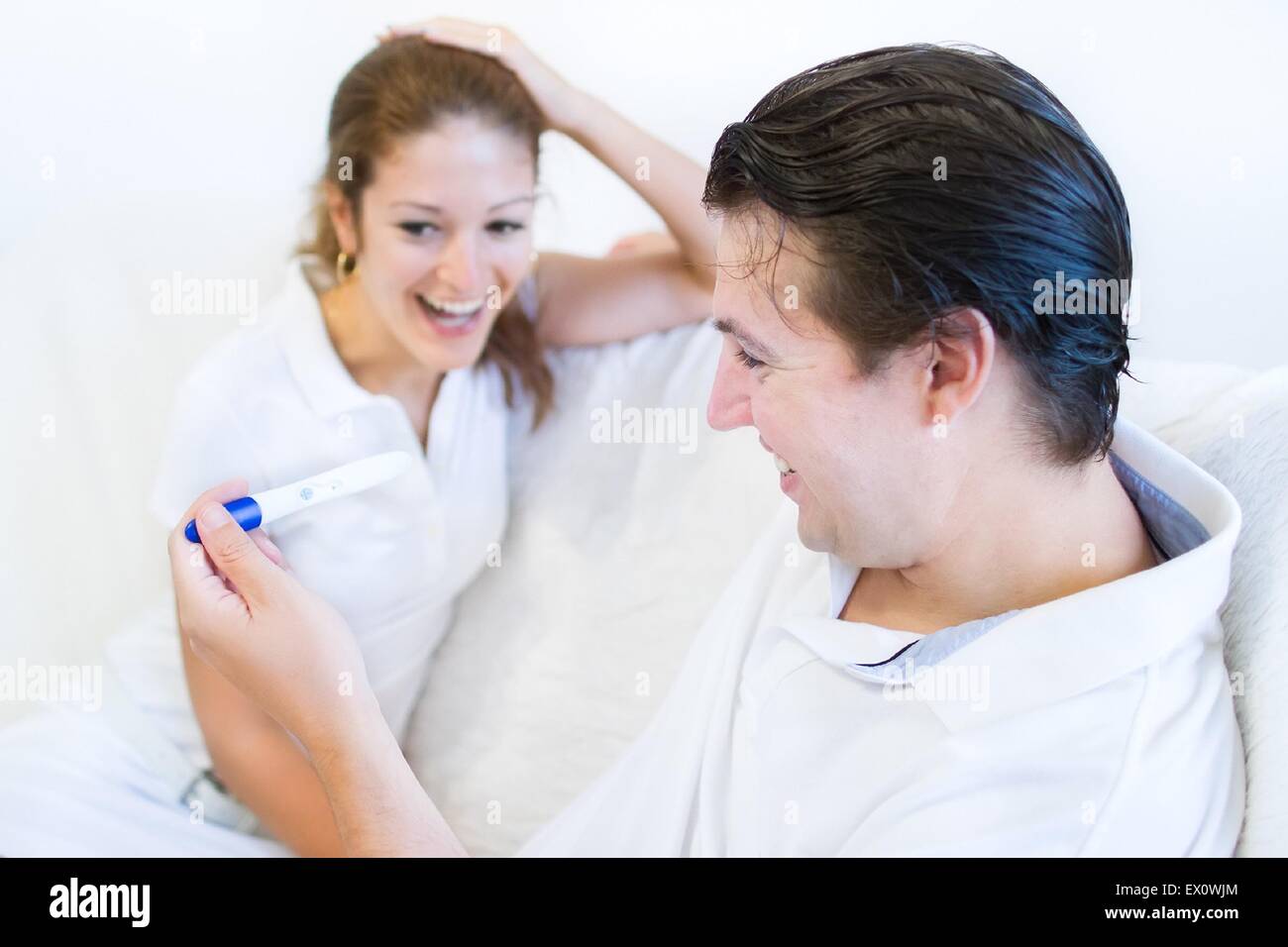 Excited young couple looking at a positive pregnancy test Stock Photo ...
