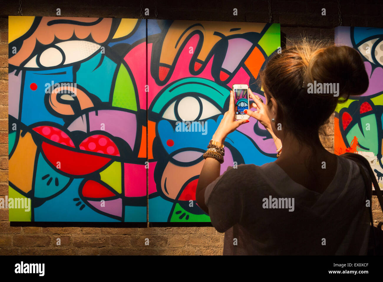 London, UK. 2 July 2015. A woman looks at an artwork by Italian artist ...