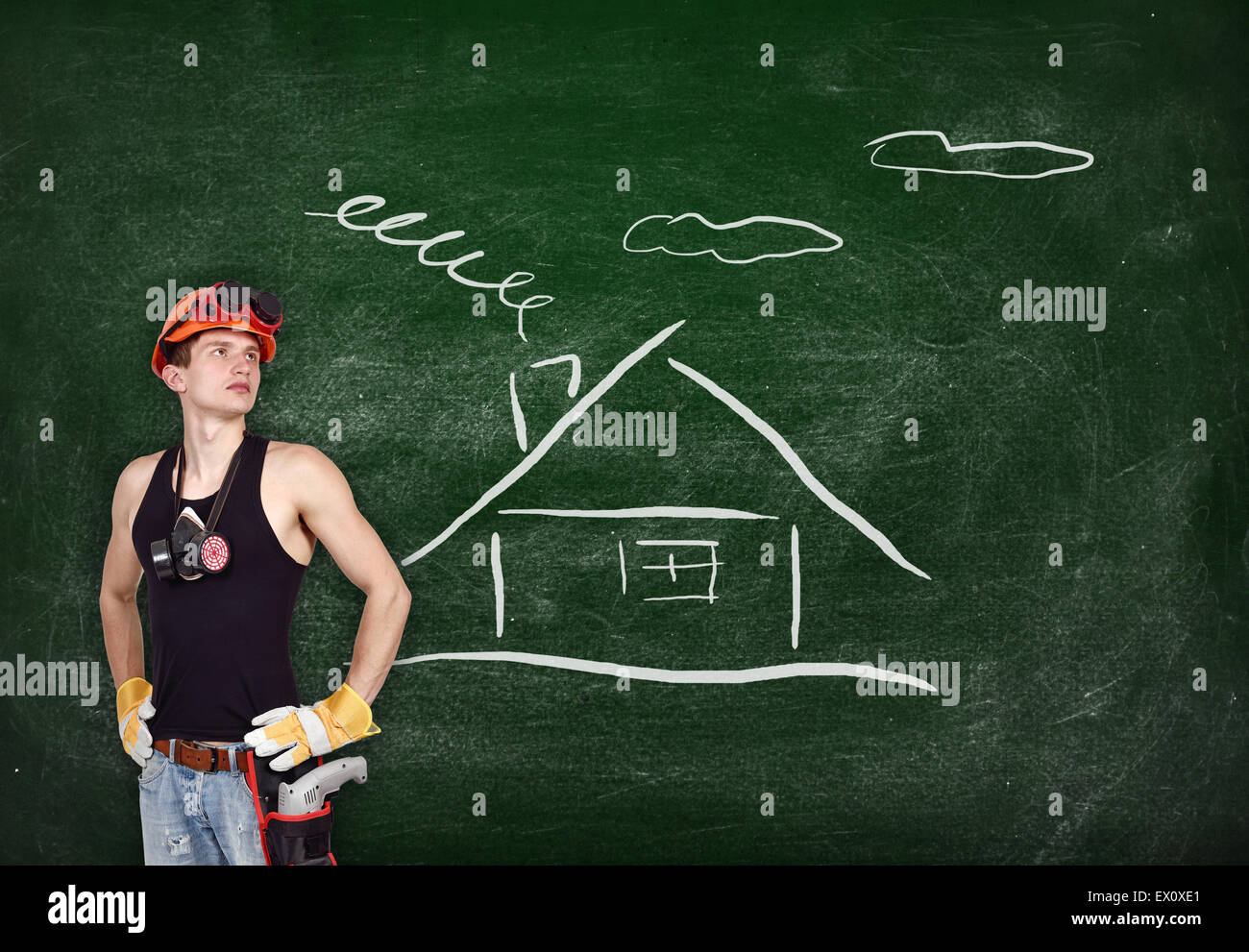 repairman with drill and drawing house on blackboard Stock Photo - Alamy