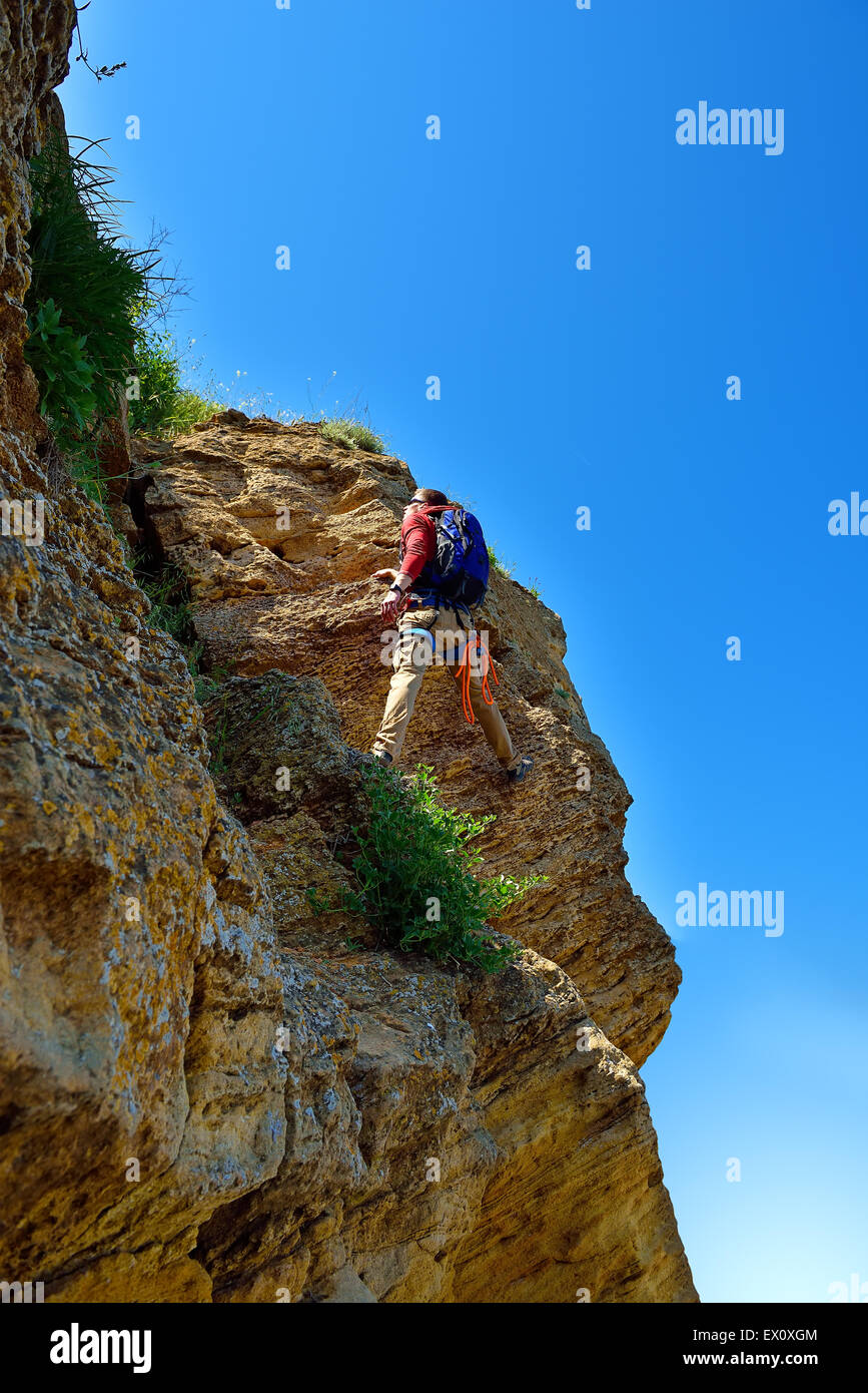 young rock climber climbing up a cliff Stock Photo - Alamy