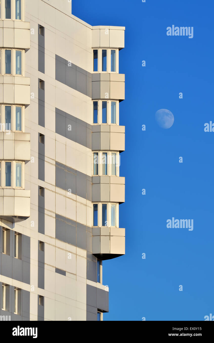 New building and the Moon on blue sky background Stock Photo - Alamy