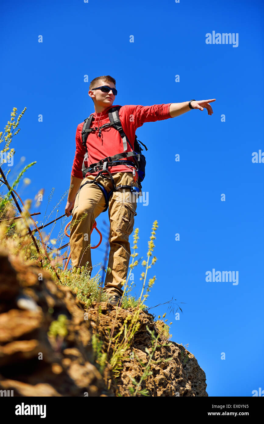 tourist on top of rock pointing hand Stock Photo - Alamy