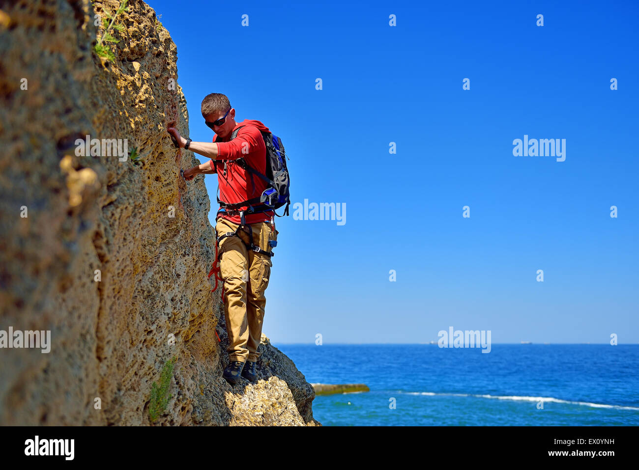 tourist walking on the cliff on a blue sky background Stock Photo - Alamy