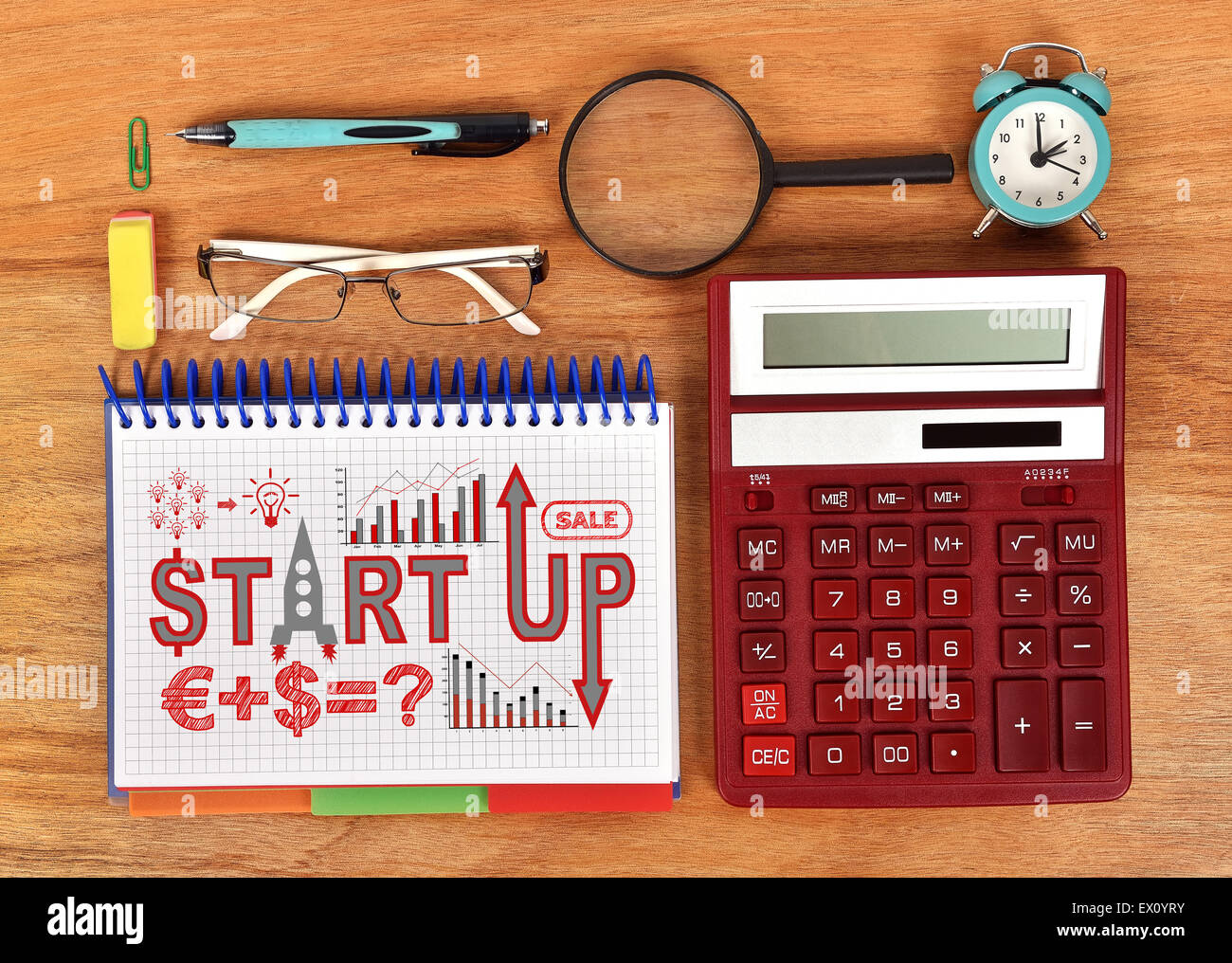 start up diagram in notebook and red calculator Stock Photo - Alamy