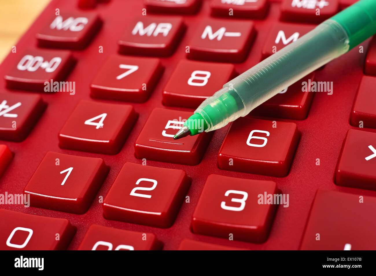 red calculator with pen, extra close up Stock Photo - Alamy