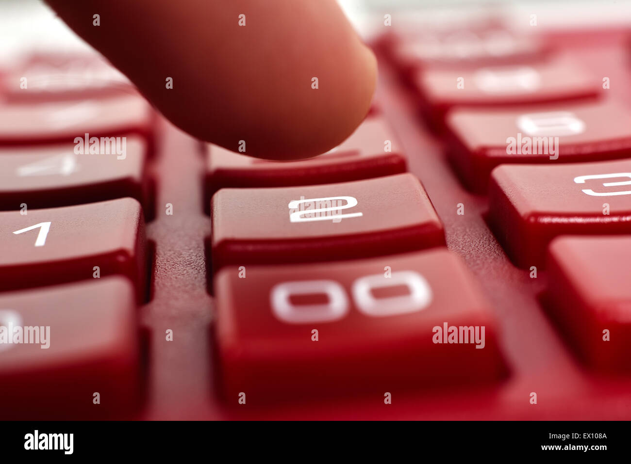finger pushing calculator buttons, extra close up Stock Photo - Alamy