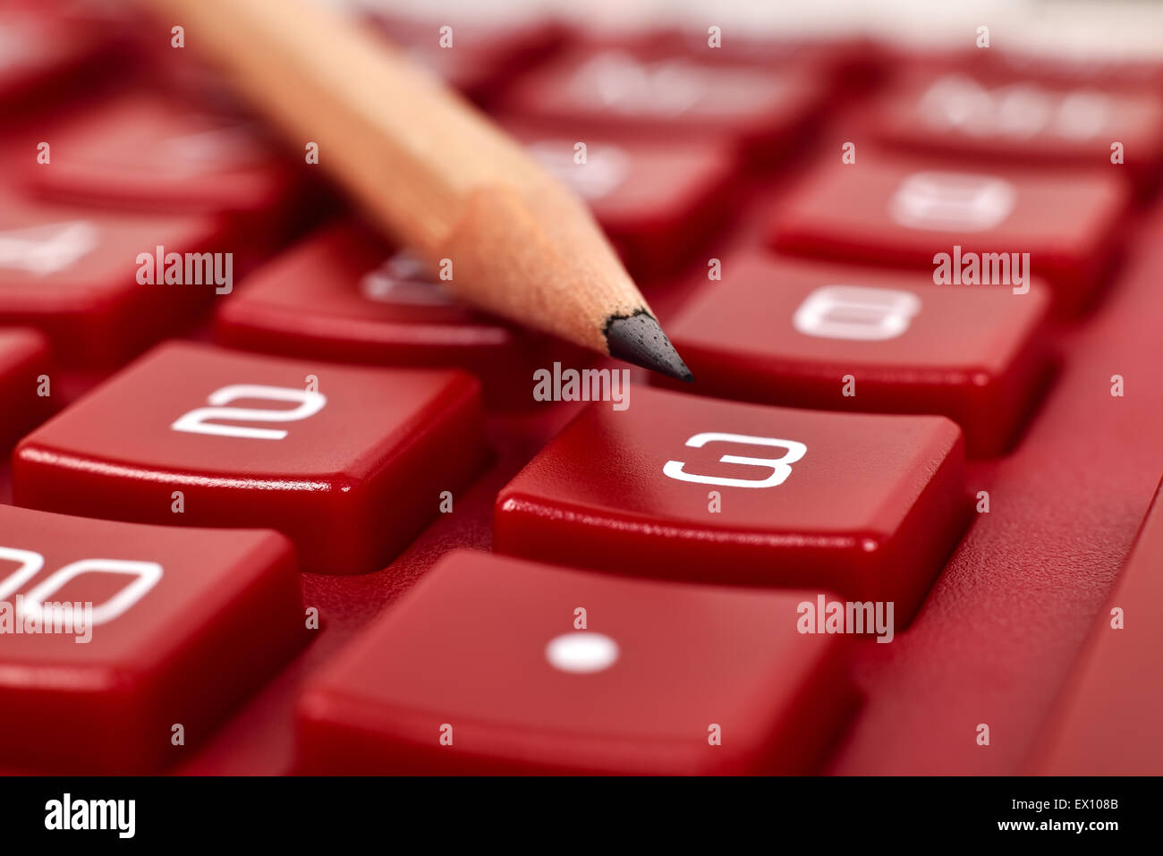red calculator with pencil, extra close up Stock Photo - Alamy