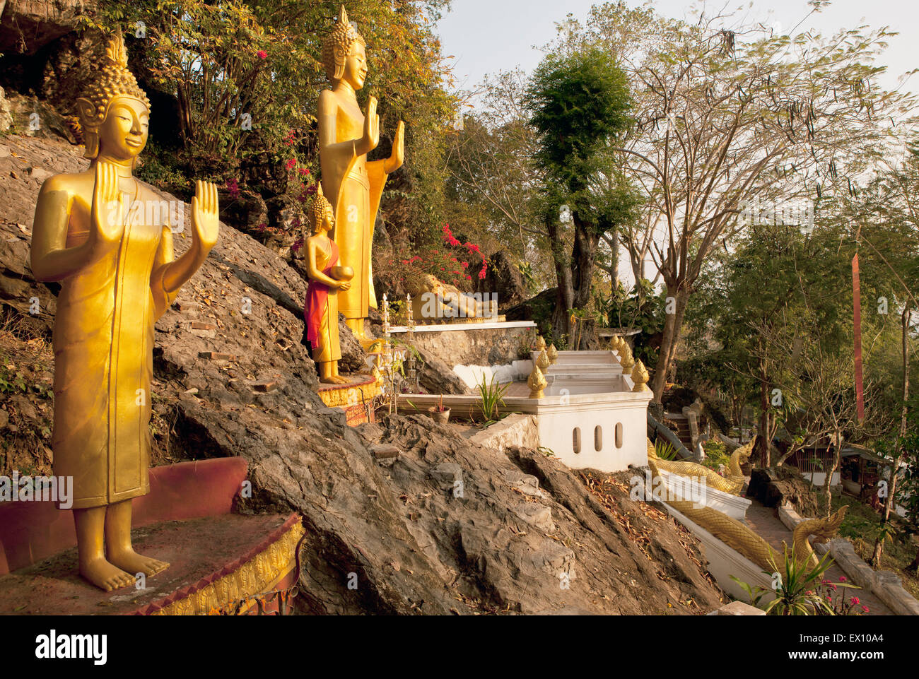 These golden statues on the Ban Khamyong side of Mt. Phou Si. depict ...