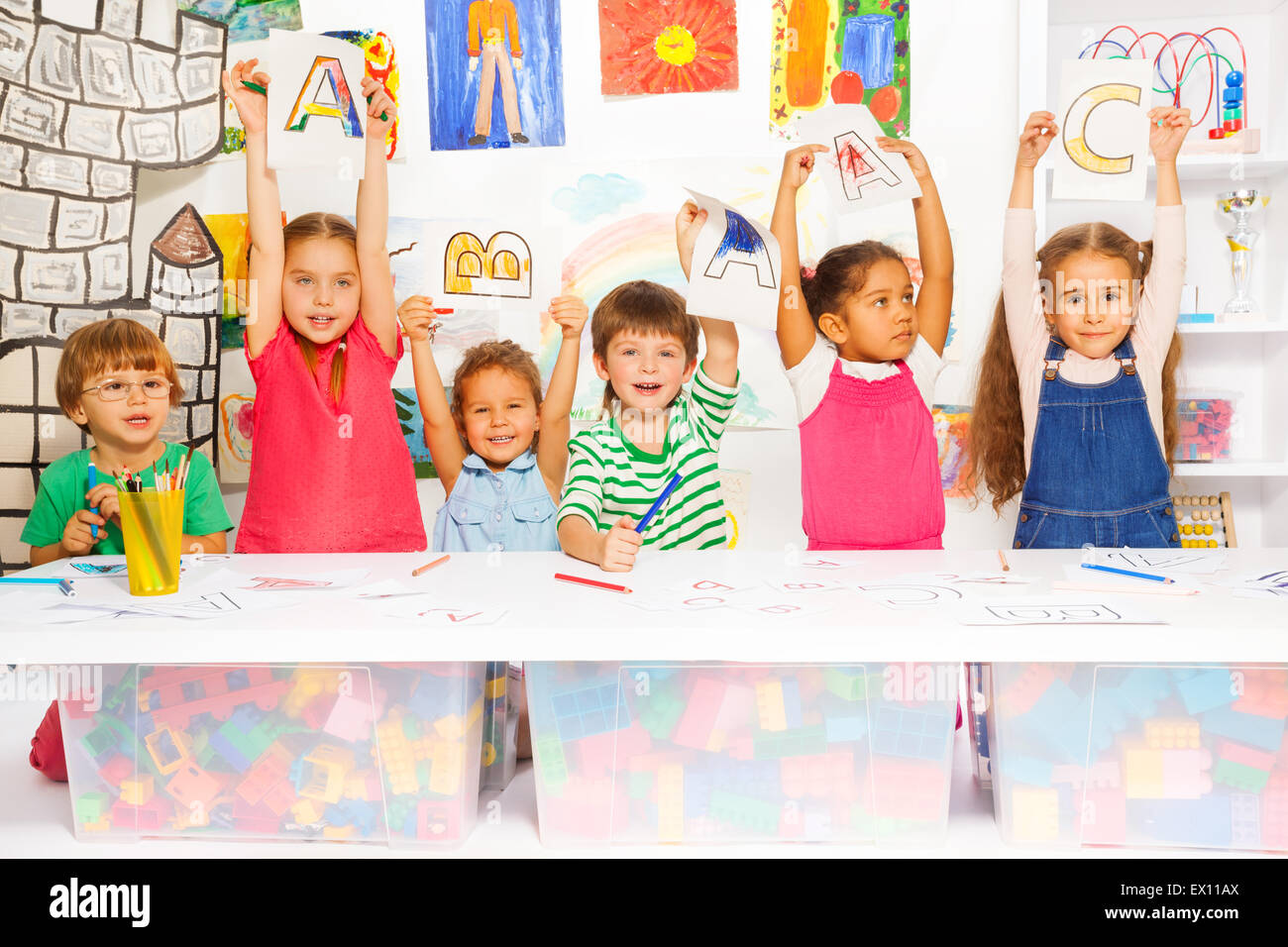 Smart little kids learning letters and writing Stock Photo - Alamy