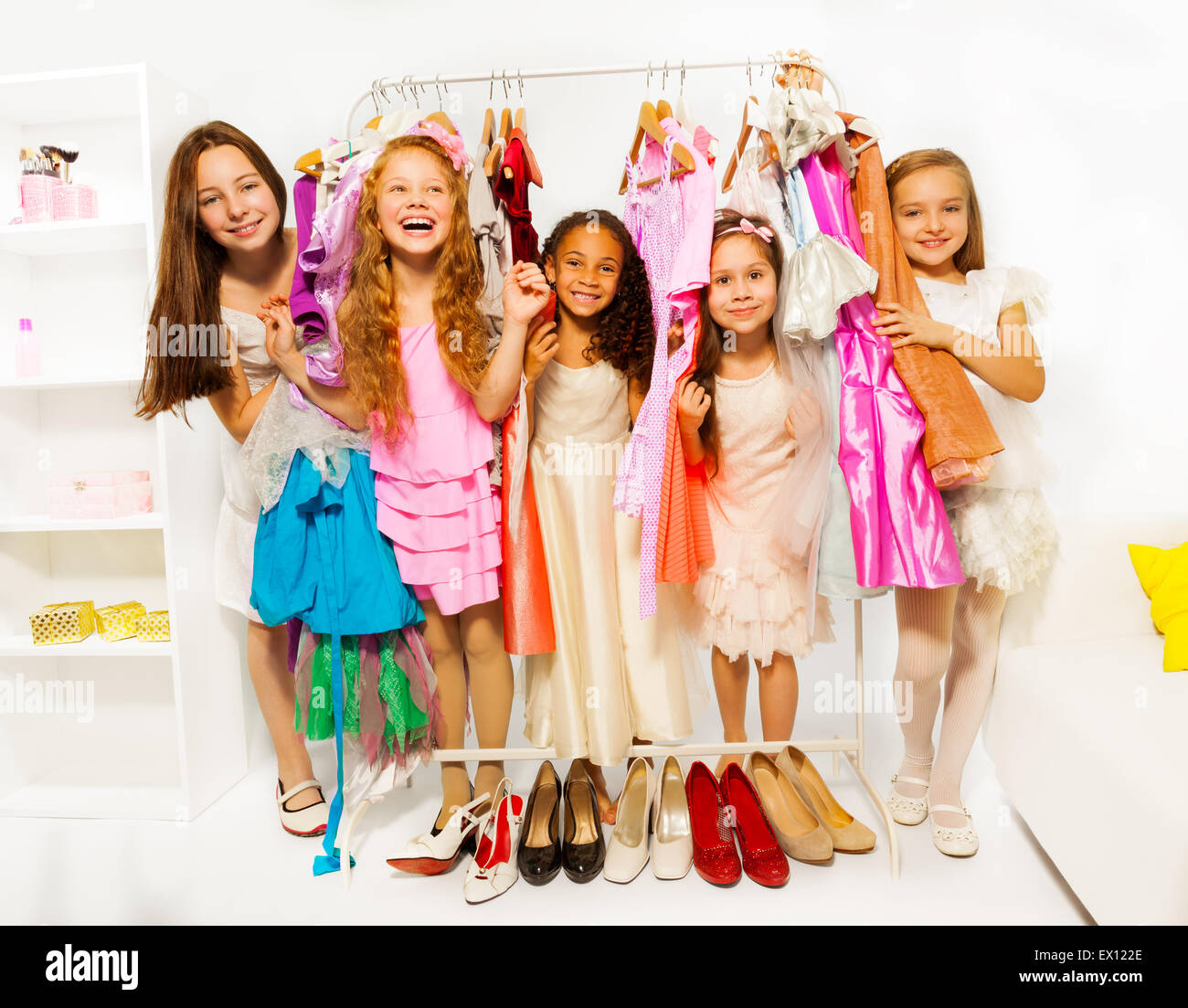 Happy girls during shopping choosing clothes Stock Photo - Alamy