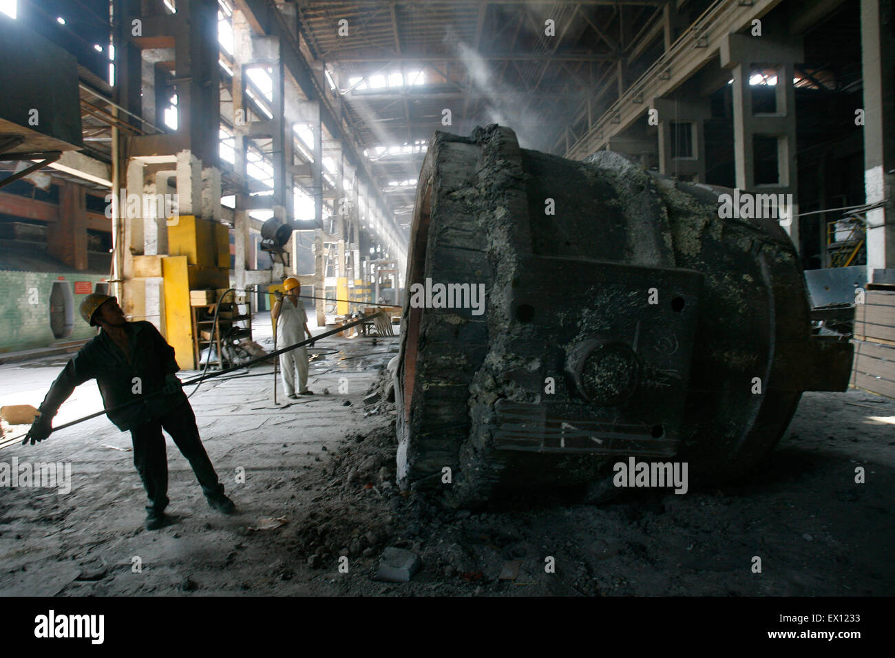 A labourer works at a workshop of an iron and steel plant in Wuhan ...