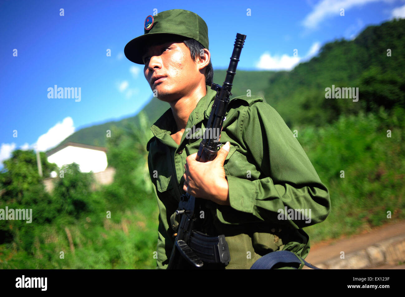 A Myanmar policeman patrols a street in Namteuk, neighbouring China's ...