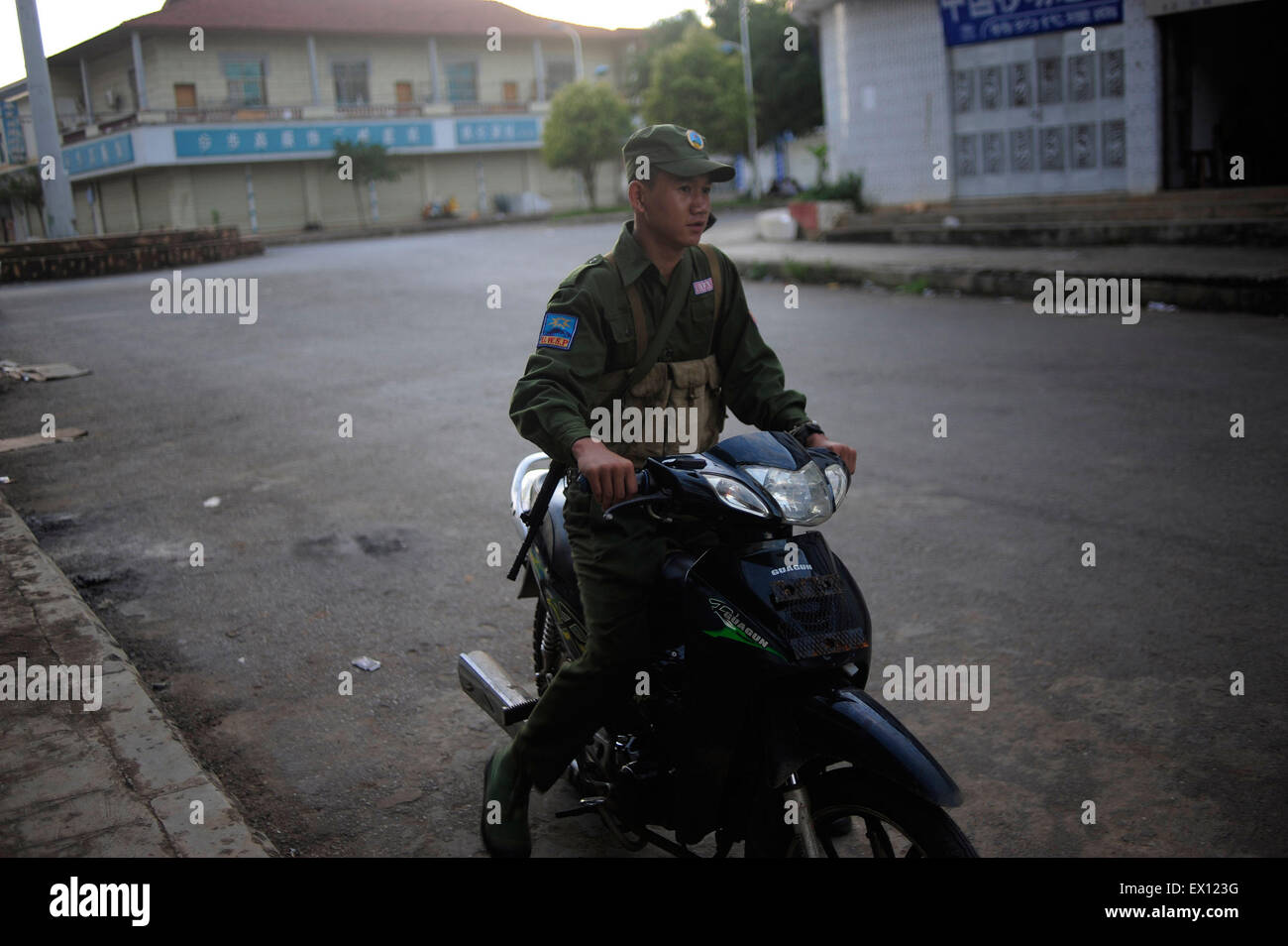 A Myanmar policeman patrols a street in Namteuk, neighbouring China's ...