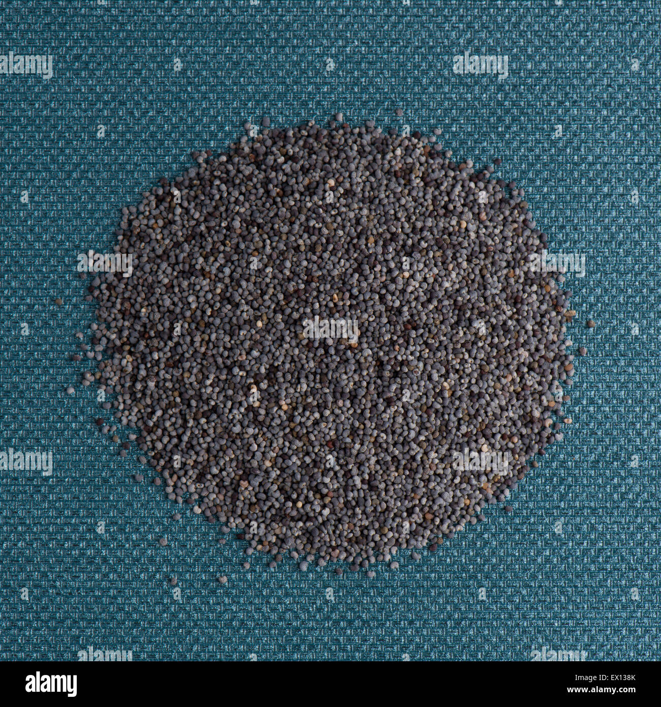 Top view of poppy seeds against blue vinyl background Stock Photo - Alamy