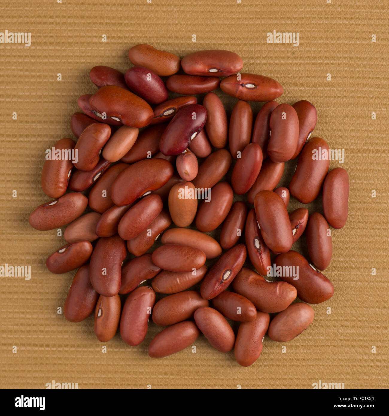 Circle of red beans on brown vinyl background Stock Photo - Alamy
