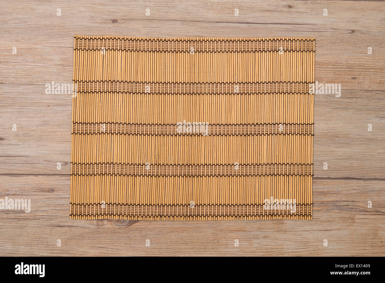 Bamboo place mat on wooden deck table Stock Photo - Alamy
