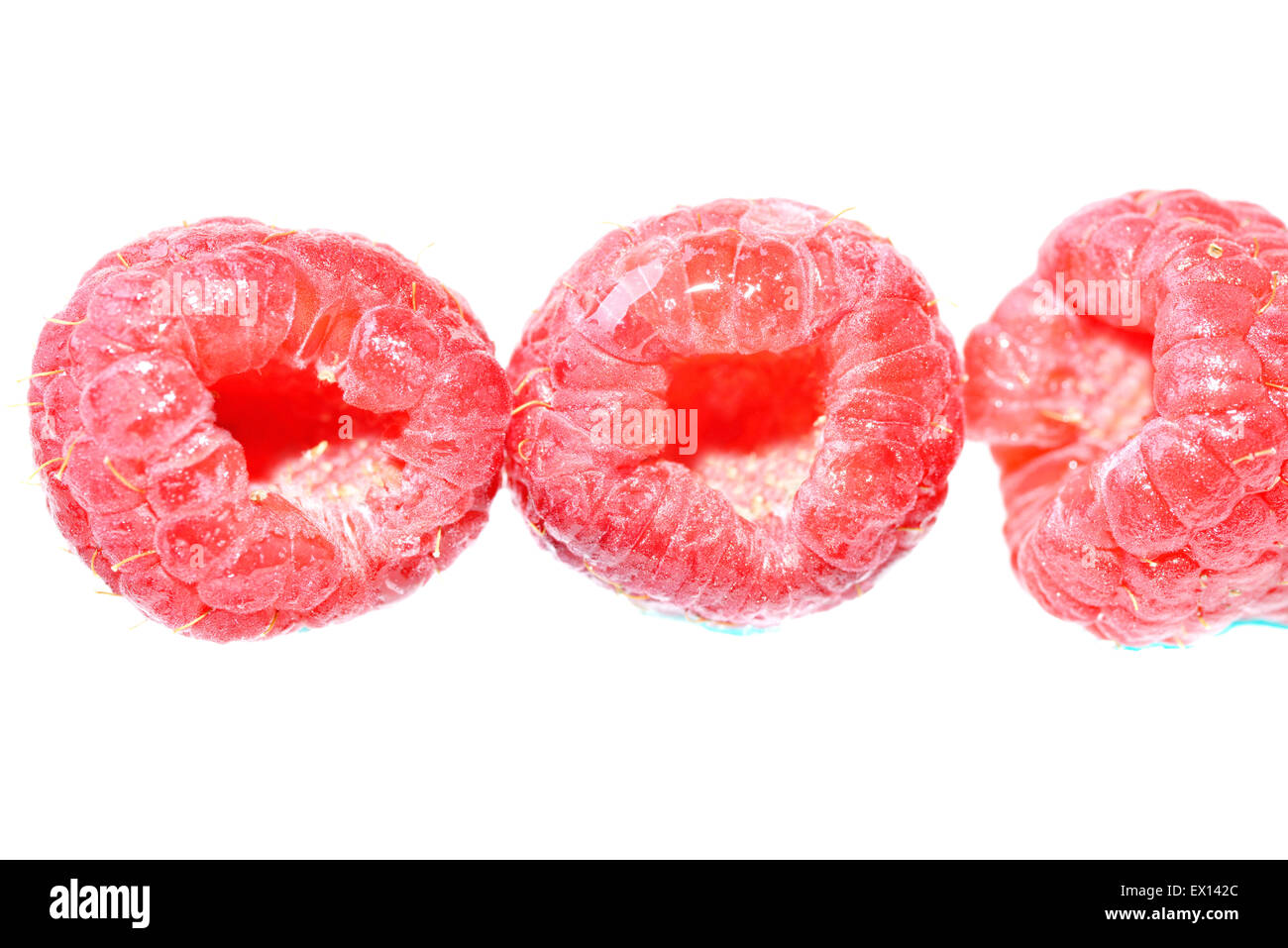 Macro shot of three raspberries over white Stock Photo - Alamy