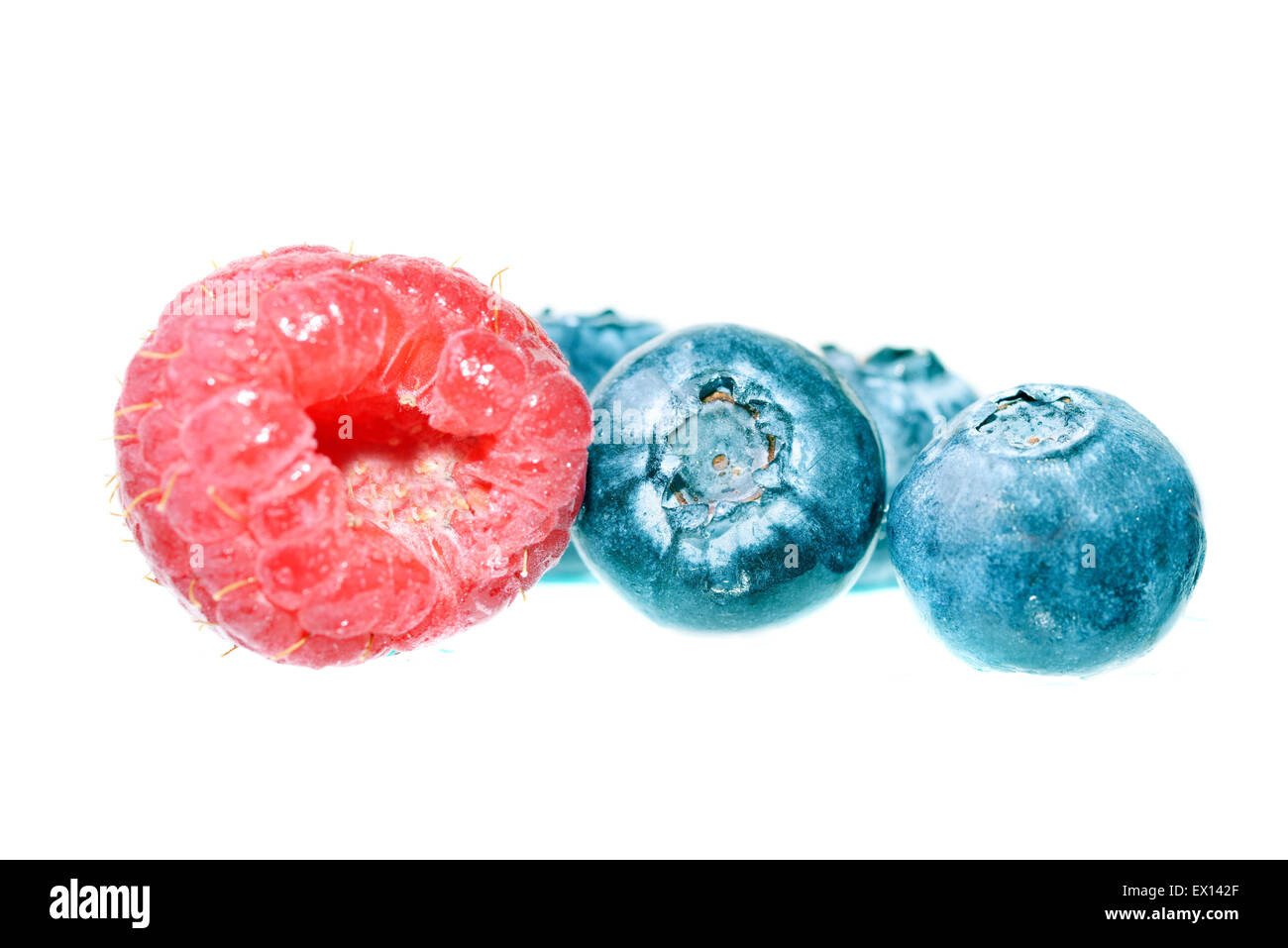 One raspberry with several blueberries isolated on white Stock Photo ...
