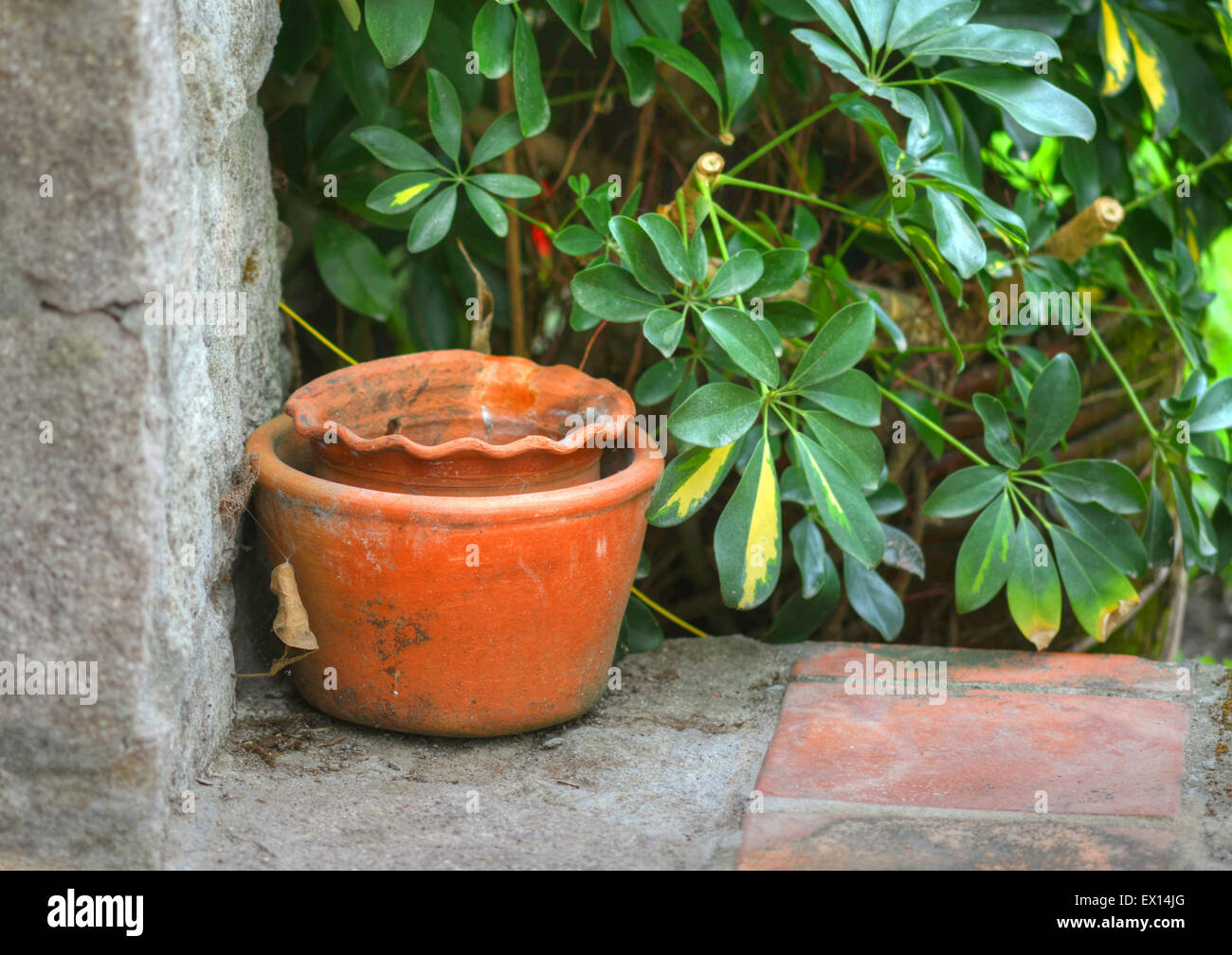 Couple of old empty clay pots on a house terrace Stock Photo - Alamy