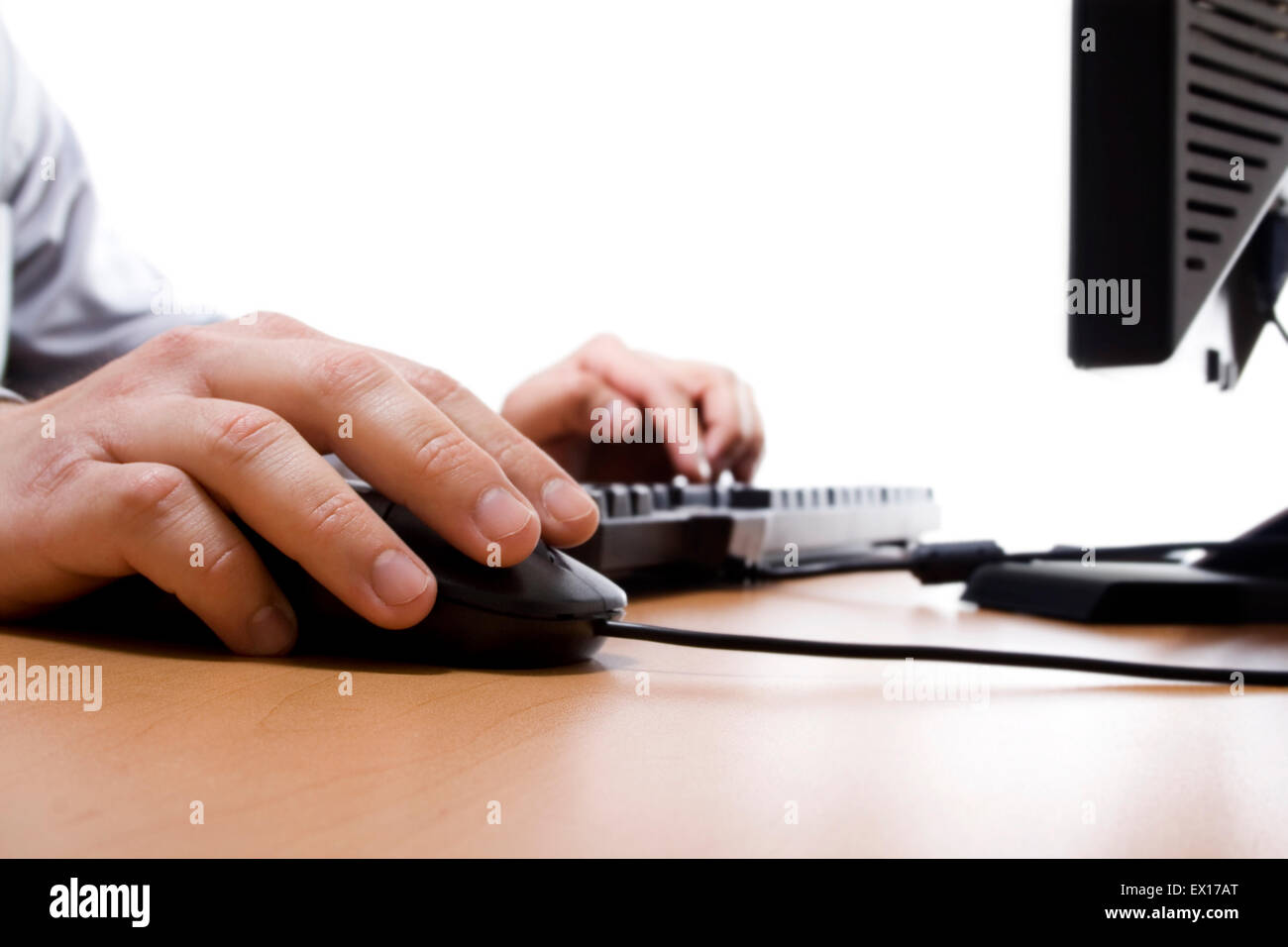 Closeup of businessman working on desktop computer over white ...