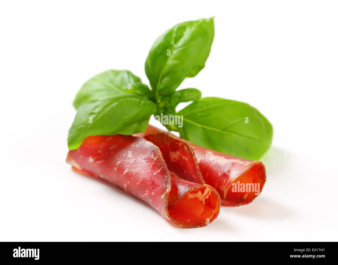 Slices of smoked marinated beef - rolled up Stock Photo - Alamy