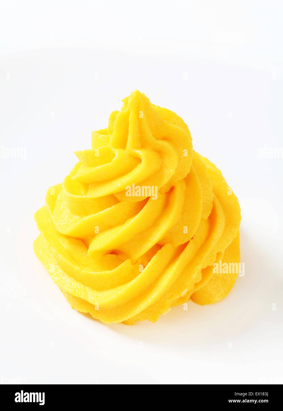 Swirl of yellow cream Stock Photo - Alamy