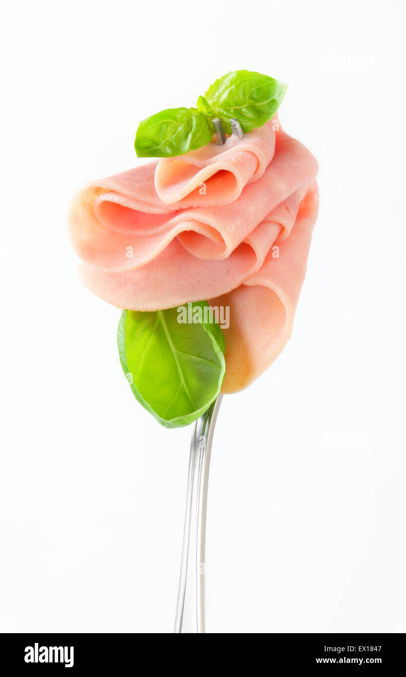 Thin slices of ham on fork Stock Photo - Alamy
