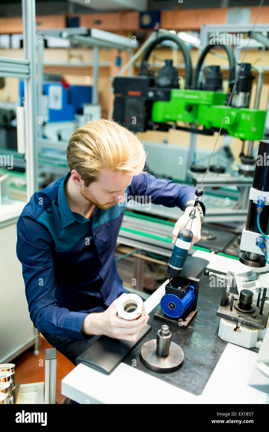 Young man in electronics workshop Stock Photo - Alamy