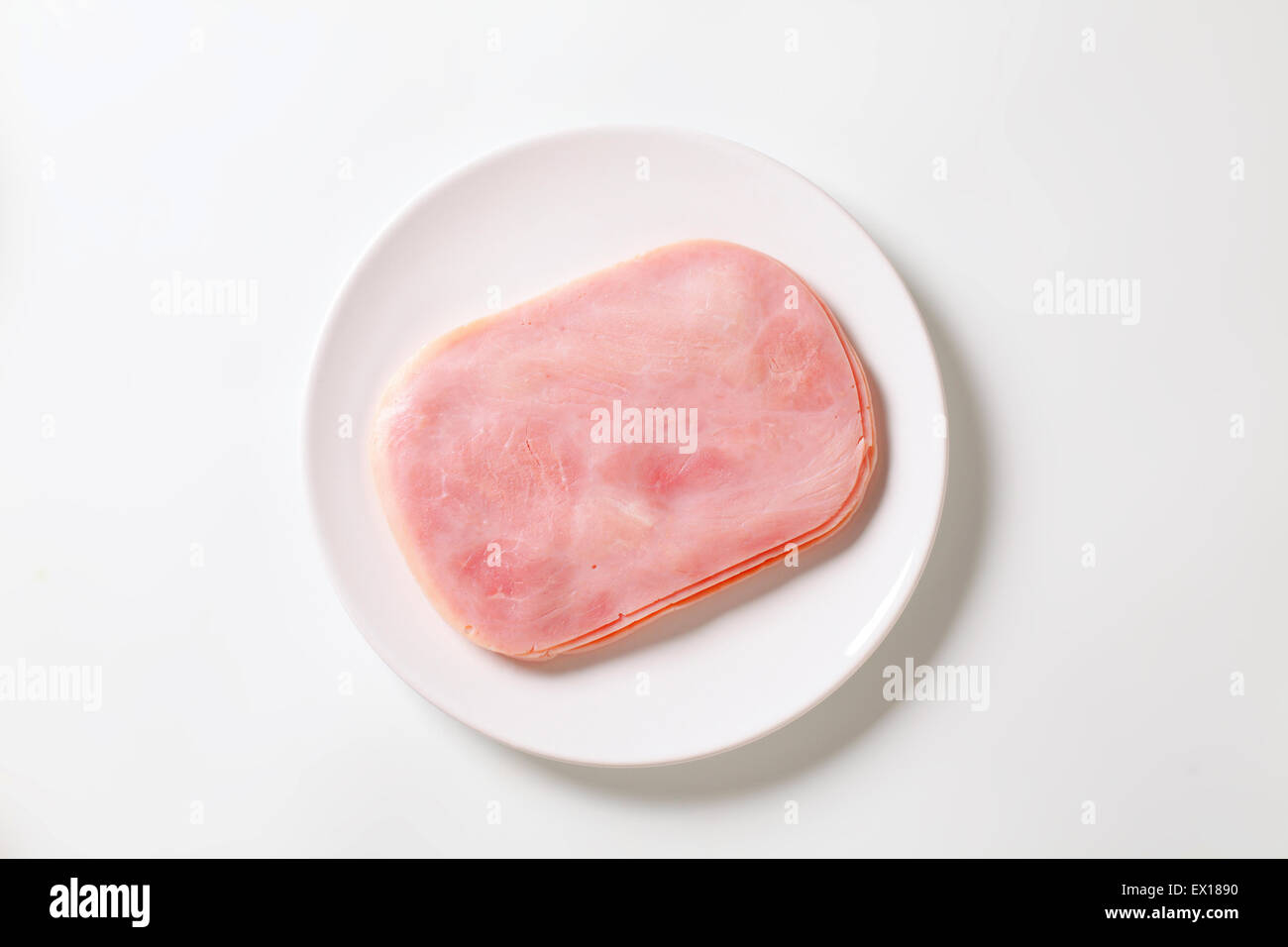 Thinly sliced ham on plate Stock Photo - Alamy