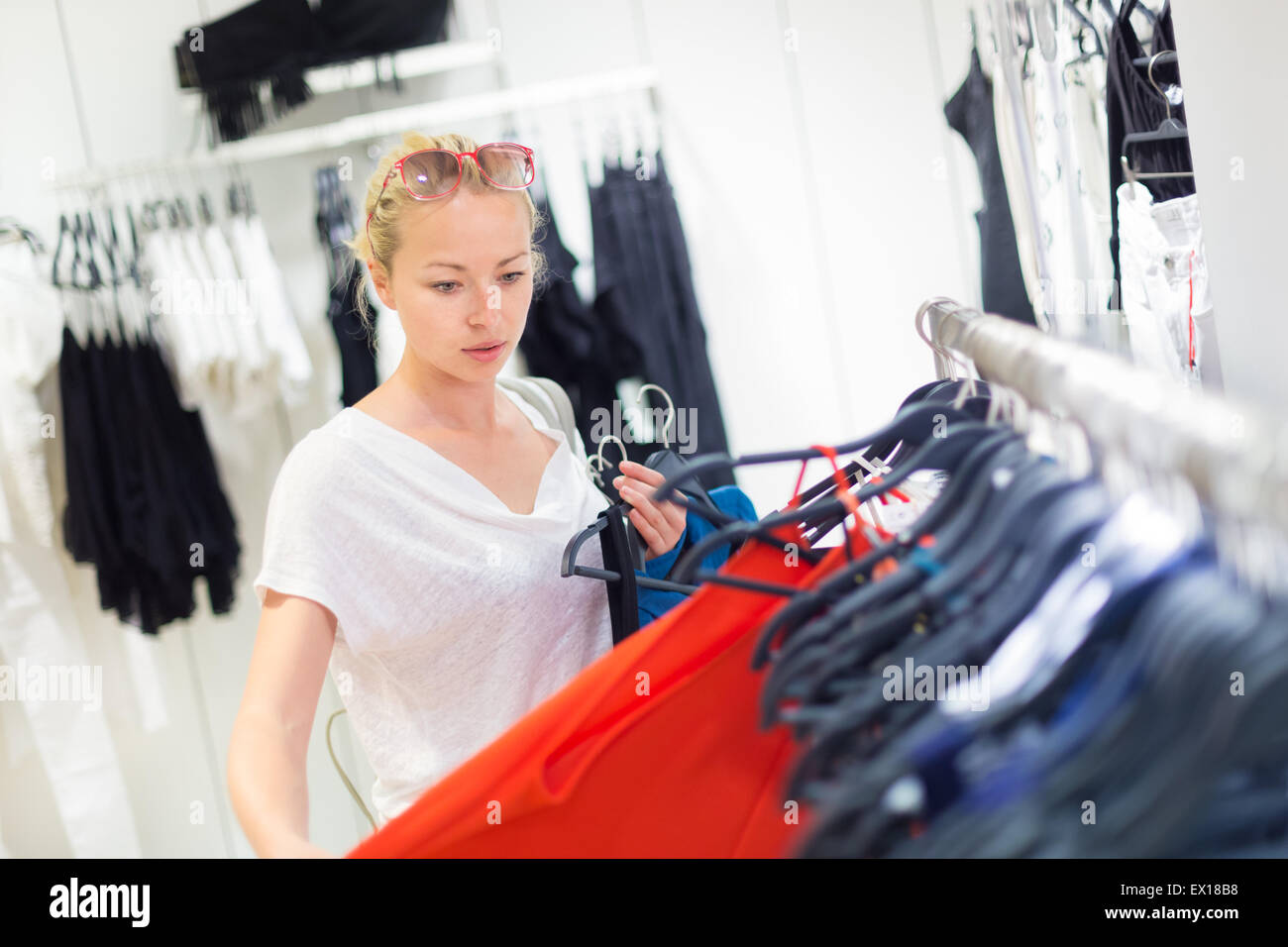 Beautiful woman shopping in clothing store Stock Photo - Alamy