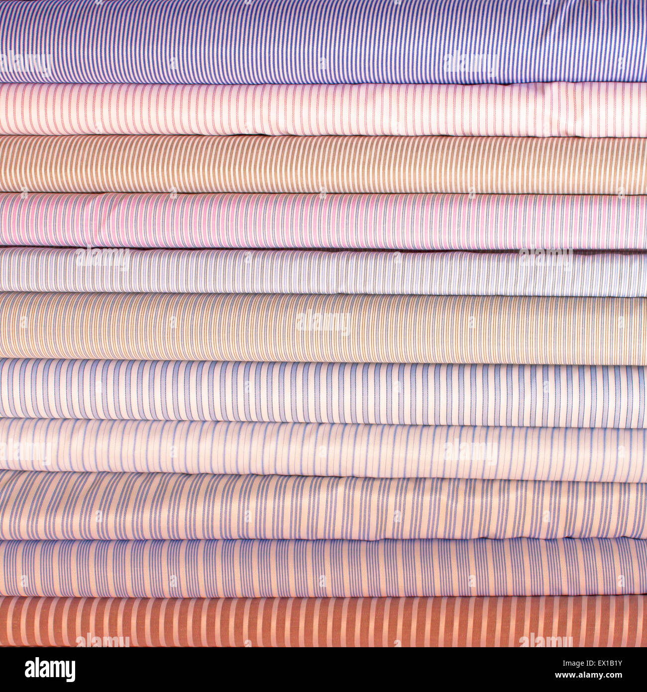 Rainbow clothes background. Pile of bright folded clothes Stock Photo ...