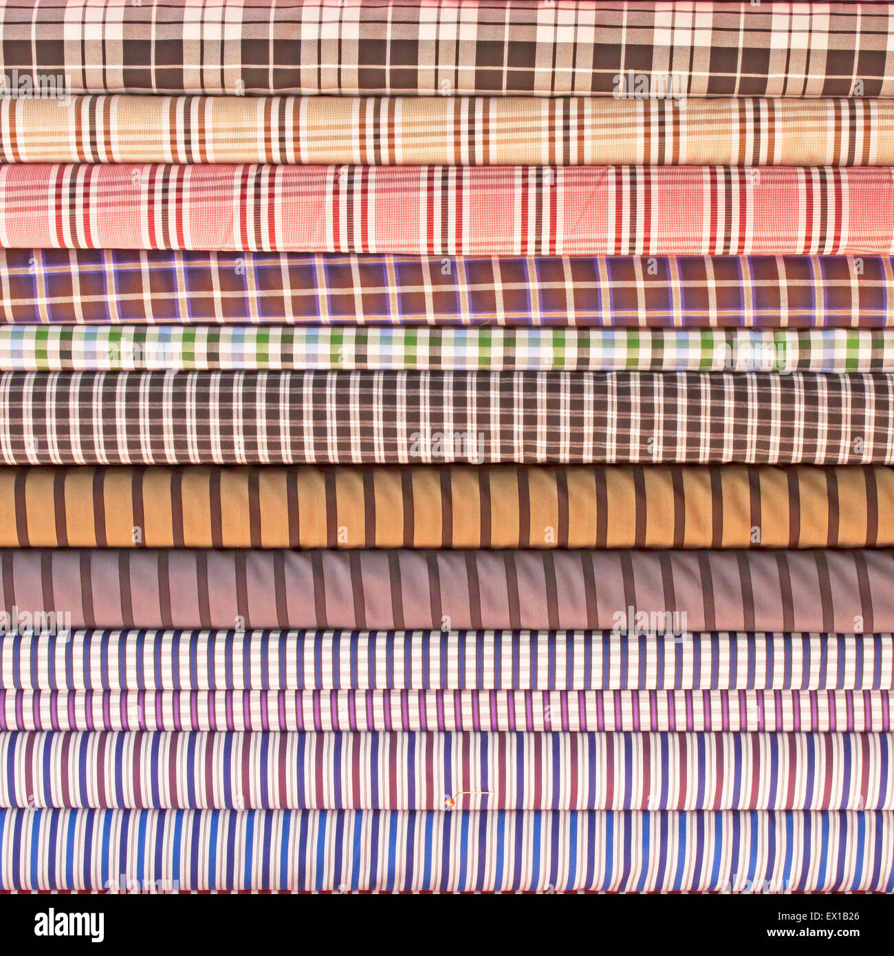 Rainbow clothes background. Pile of bright folded clothes Stock Photo ...