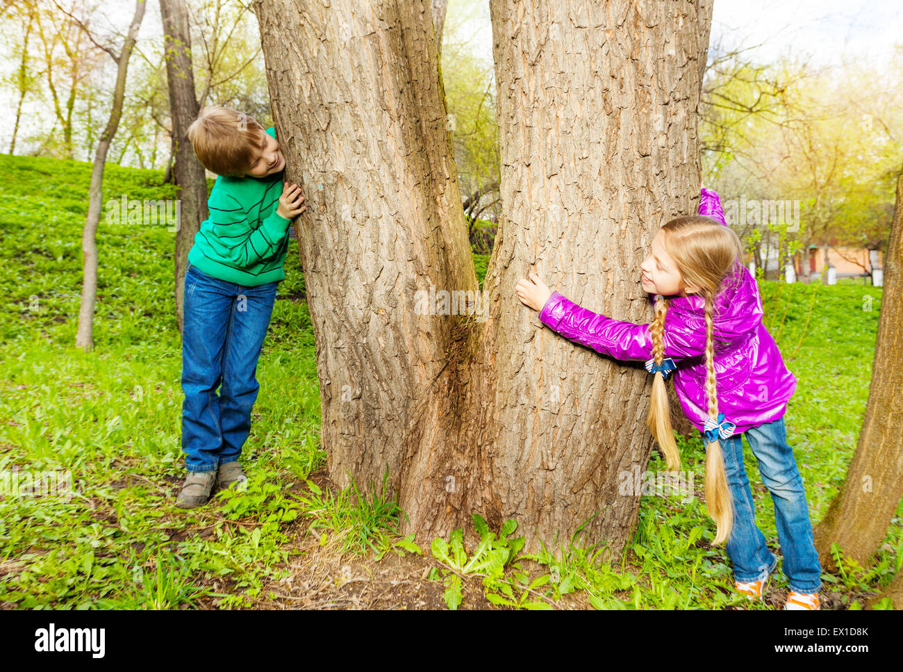 Girl boy playing hide seek hi-res stock photography and images - Alamy