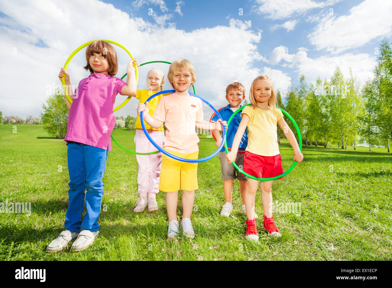 Boy girl hula hoop children grass hi-res stock photography and images ...