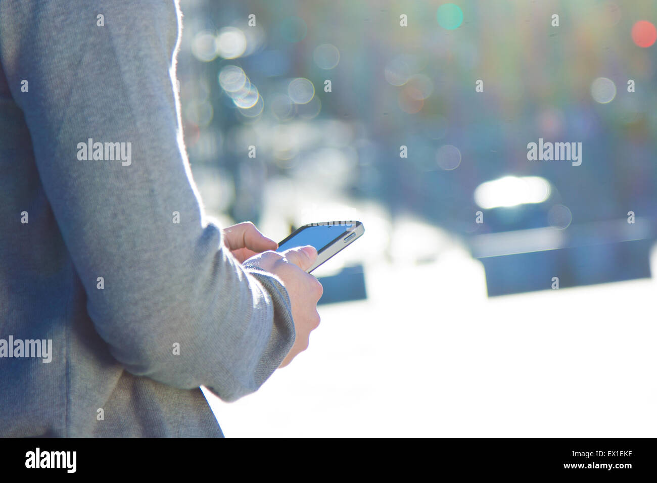 Young man chatting with their smartphone in the street Stock Photo - Alamy