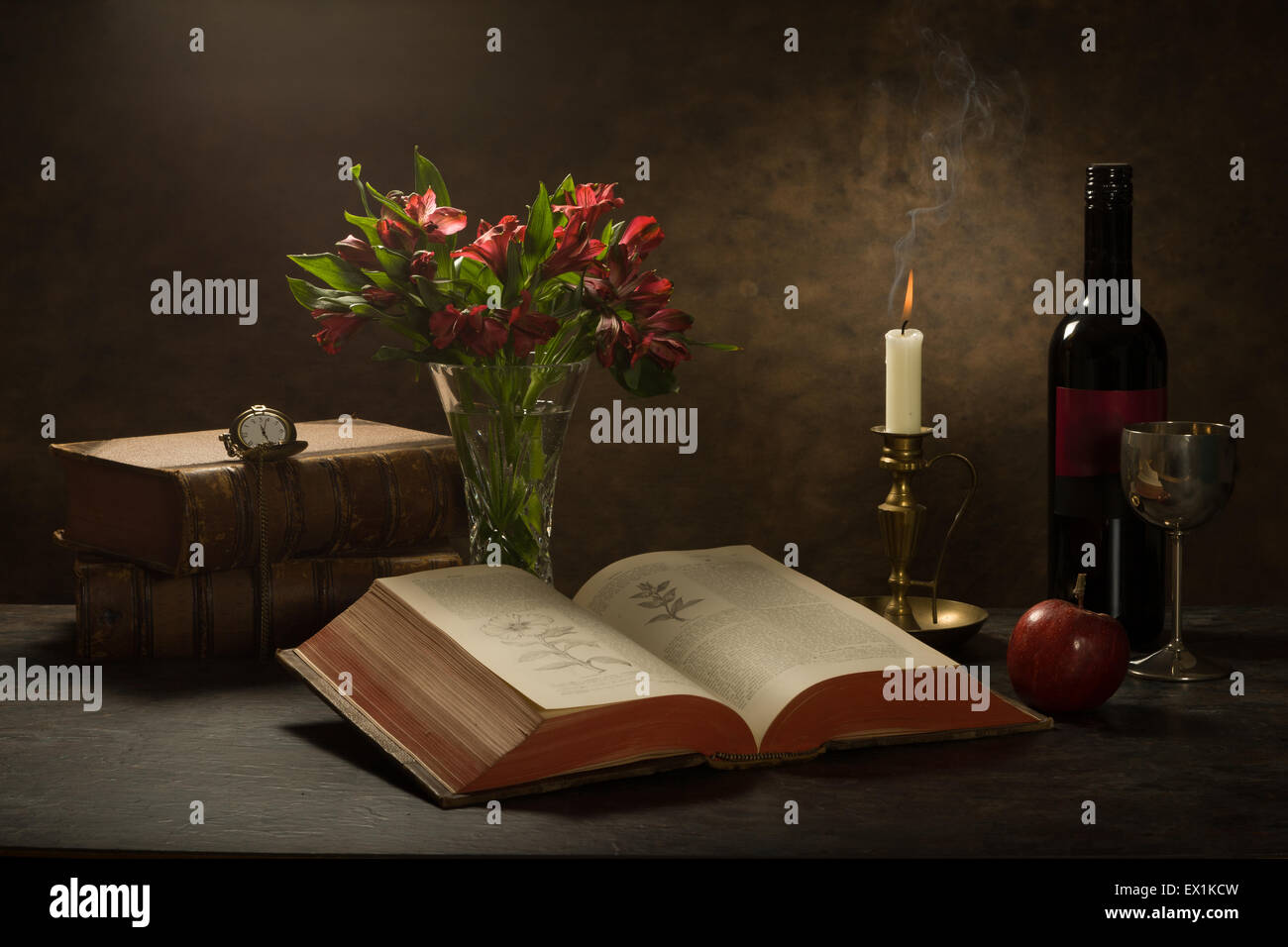 still life of an open bible dictionary on a table with a candle, wine ...